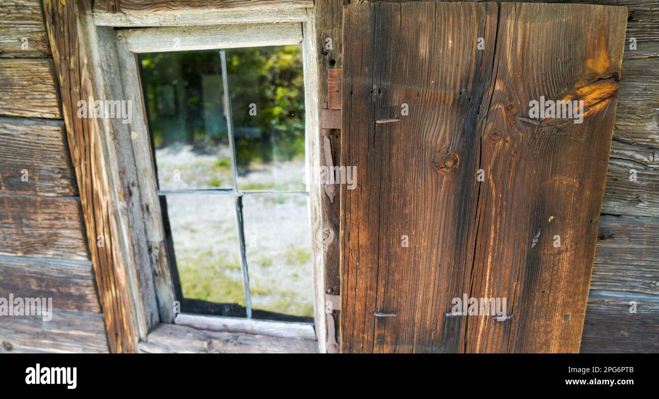 Aged wooden window with glazing and partially weathered in rustic homes ...