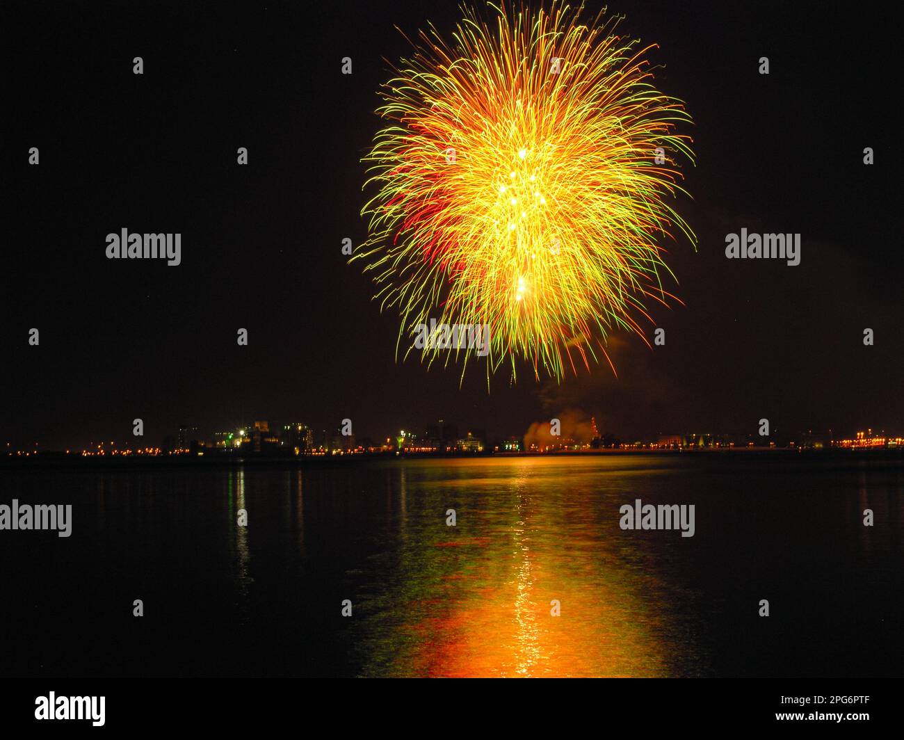 fireworks in the night sky, reflecting in the water Stock Photo - Alamy