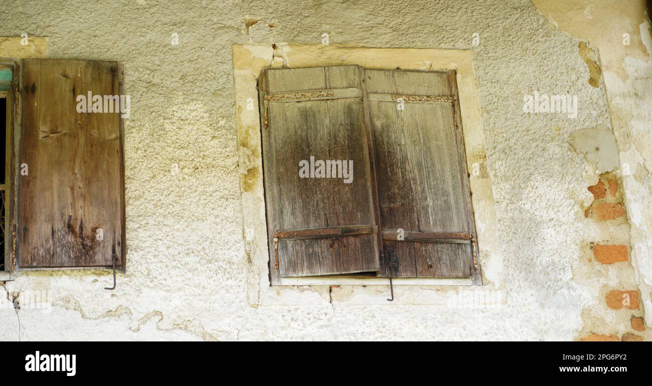Aged wooden window with glazing and partially weathered in rustic homes ...