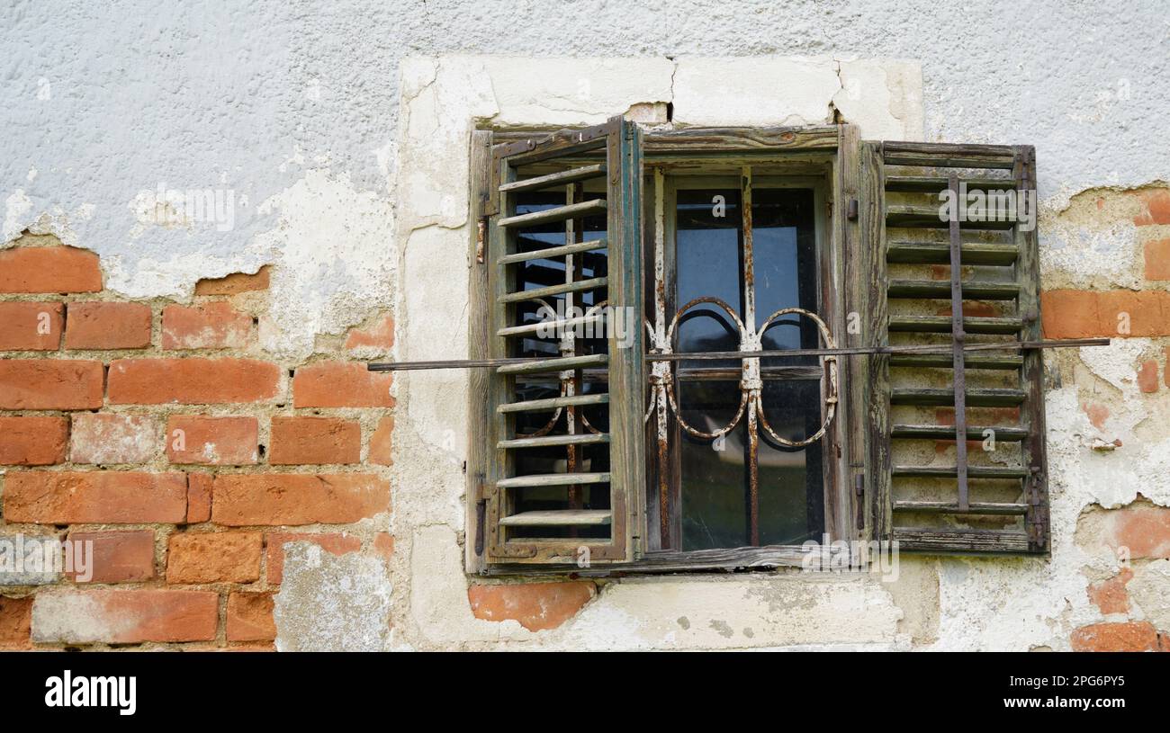 Aged wooden window with glazing and partially weathered in rustic homes ...