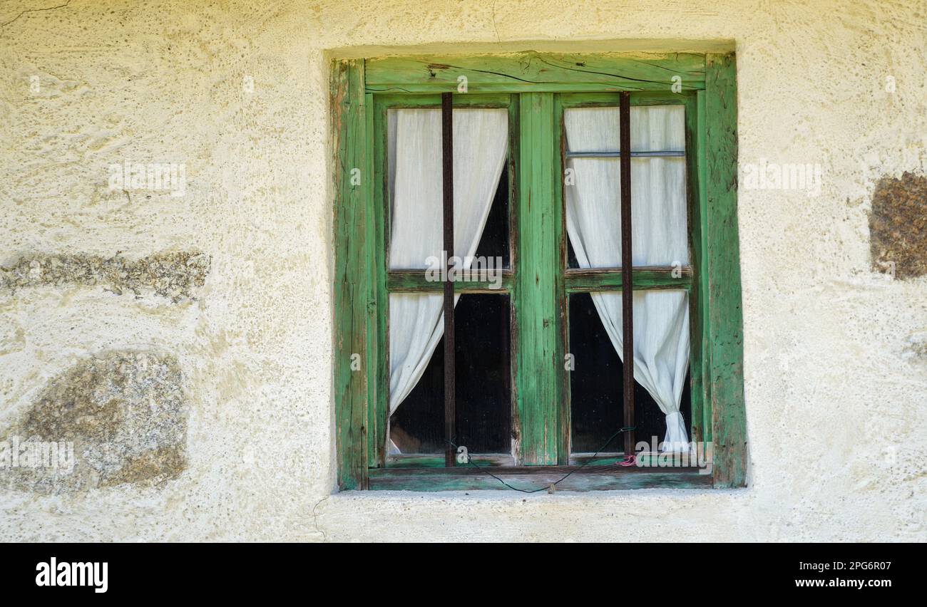 Aged wooden window with glazing and partially weathered in rustic homes ...