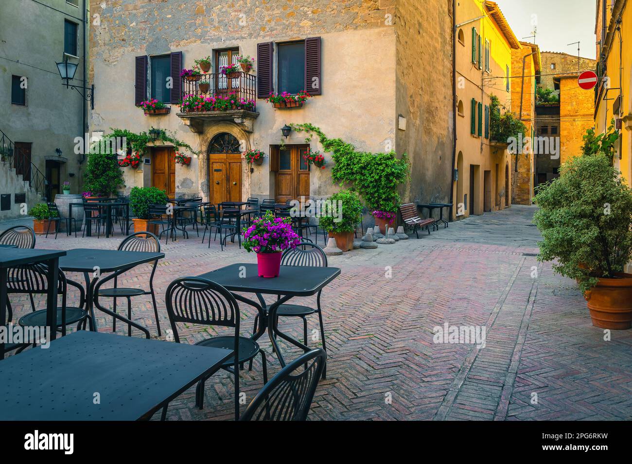 Cute street cafe with tables and chairs in the old paved street at ...