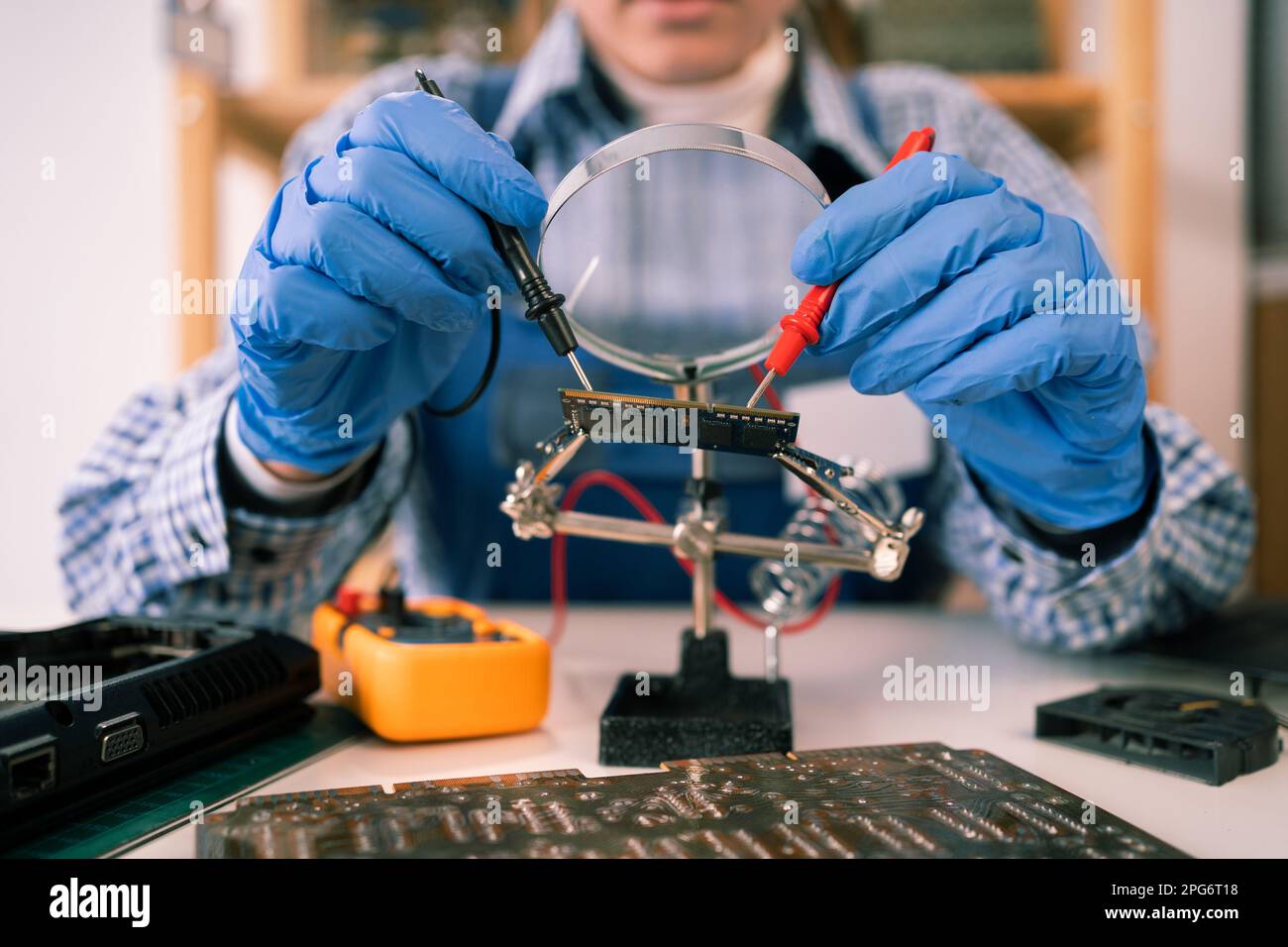 Worker testing laptop motherboard using hi-res stock photography and ...