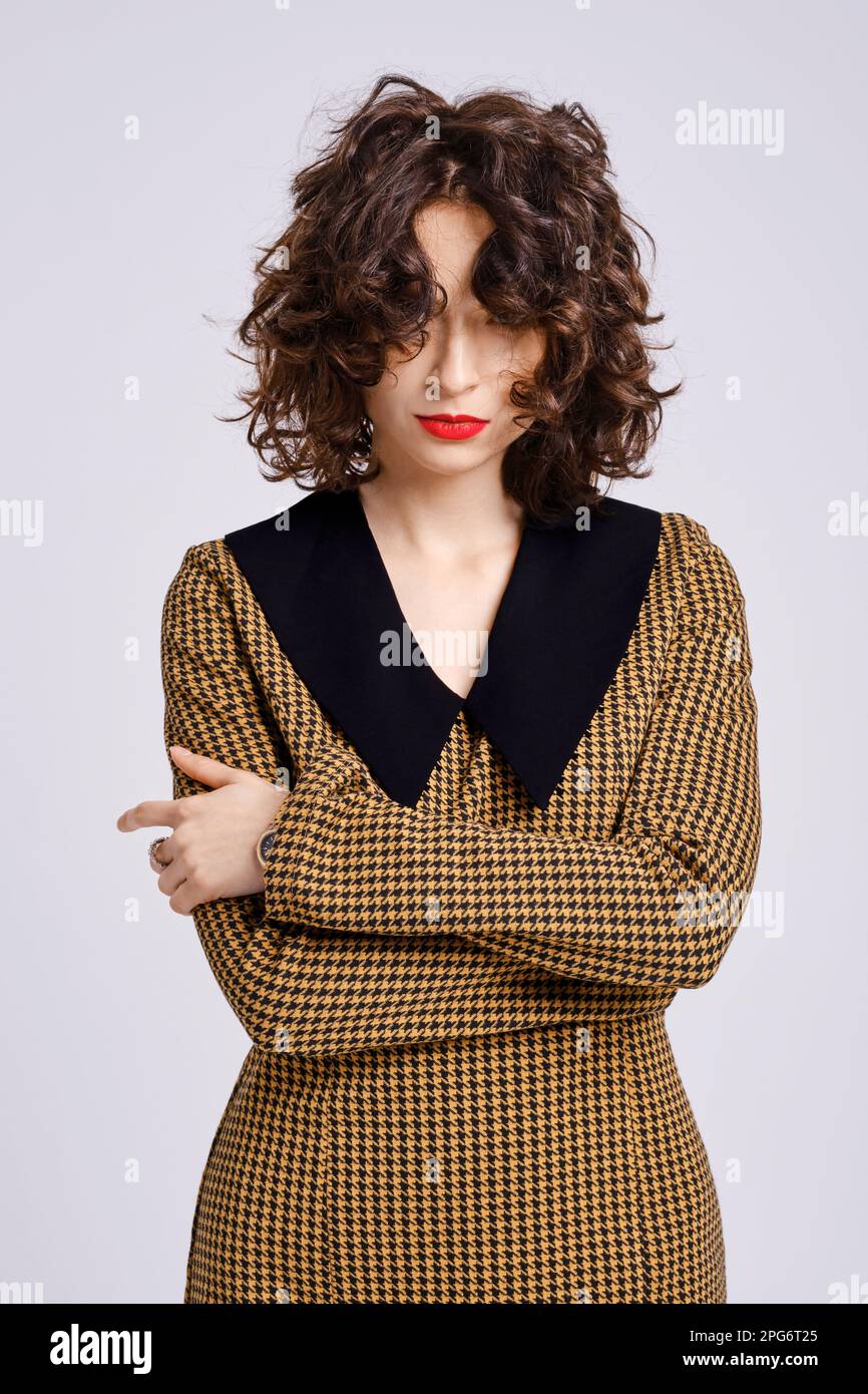 Studio portrait of tricky and playful woman with short curly hair Stock ...