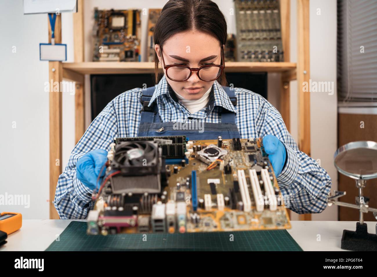 Young repairer disassembling a computer internal parts in service ...