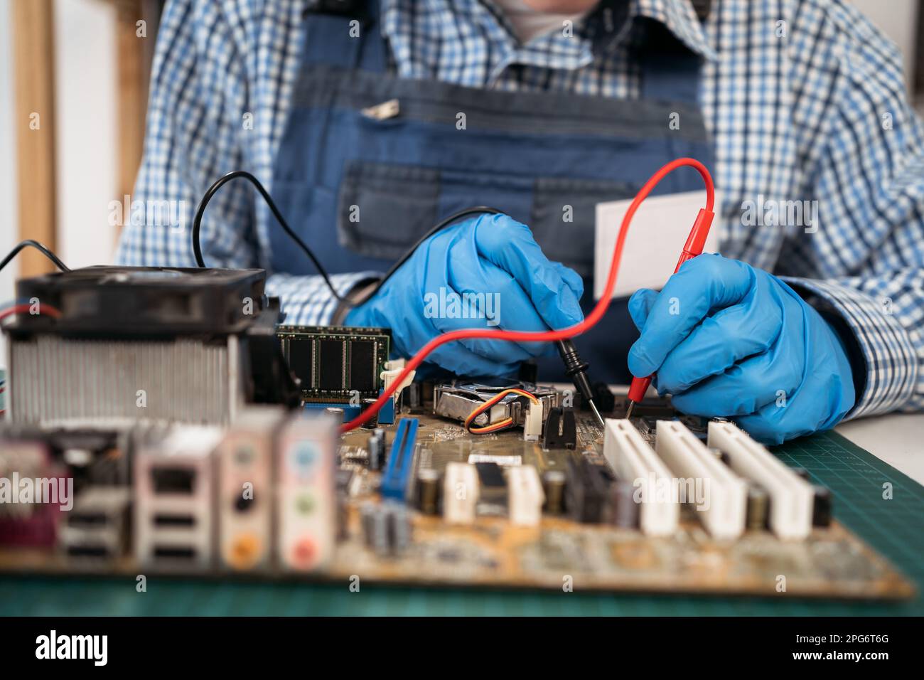 Closeup hands of female technician measuring electrical voltage of ...