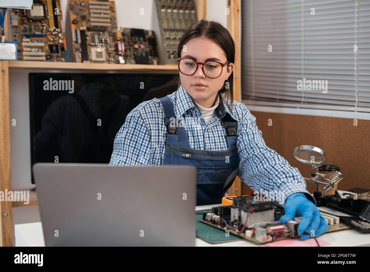 Technician repair. Broken computer motherboard. Electronic pc parts ...