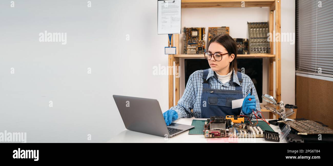 Tech tests electronic equipment in service center. Computer repair ...