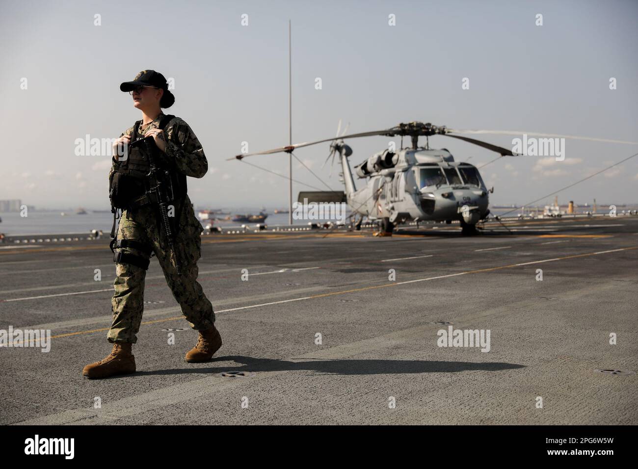 Manila, Philippines. 21st Mar, 2023. An armed US Navy walks past a ...