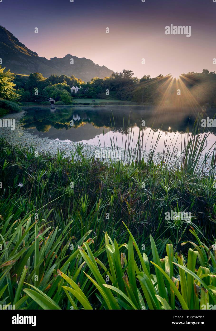 View of the Tokara homestead over a dam with the Simonsberg Mountain in ...