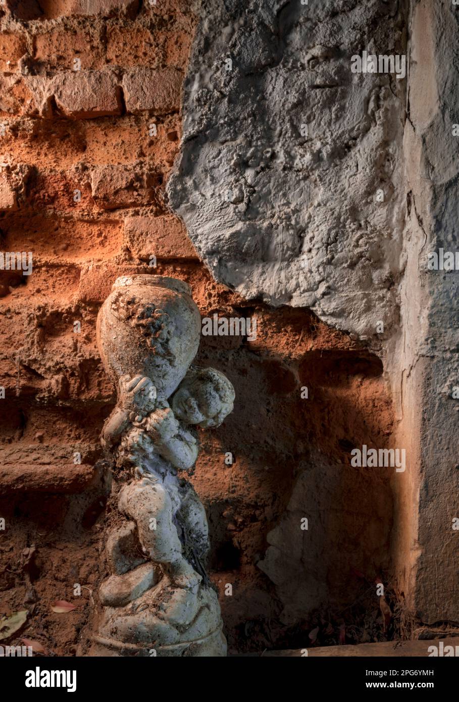 Old garden wall with cement figure Stock Photo - Alamy