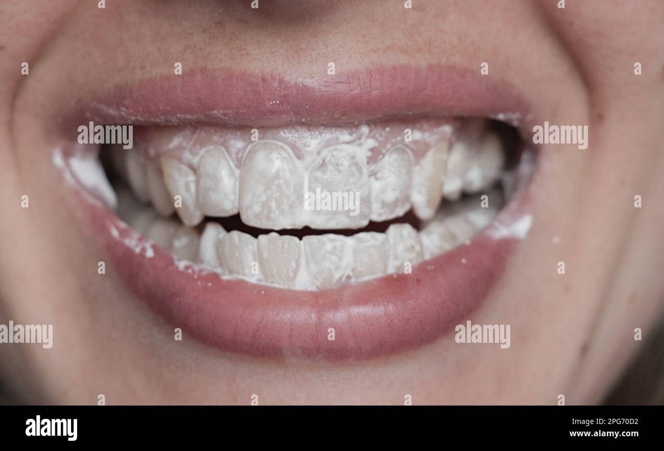 female in toothpaste closeup on blurry background Stock Photo - Alamy