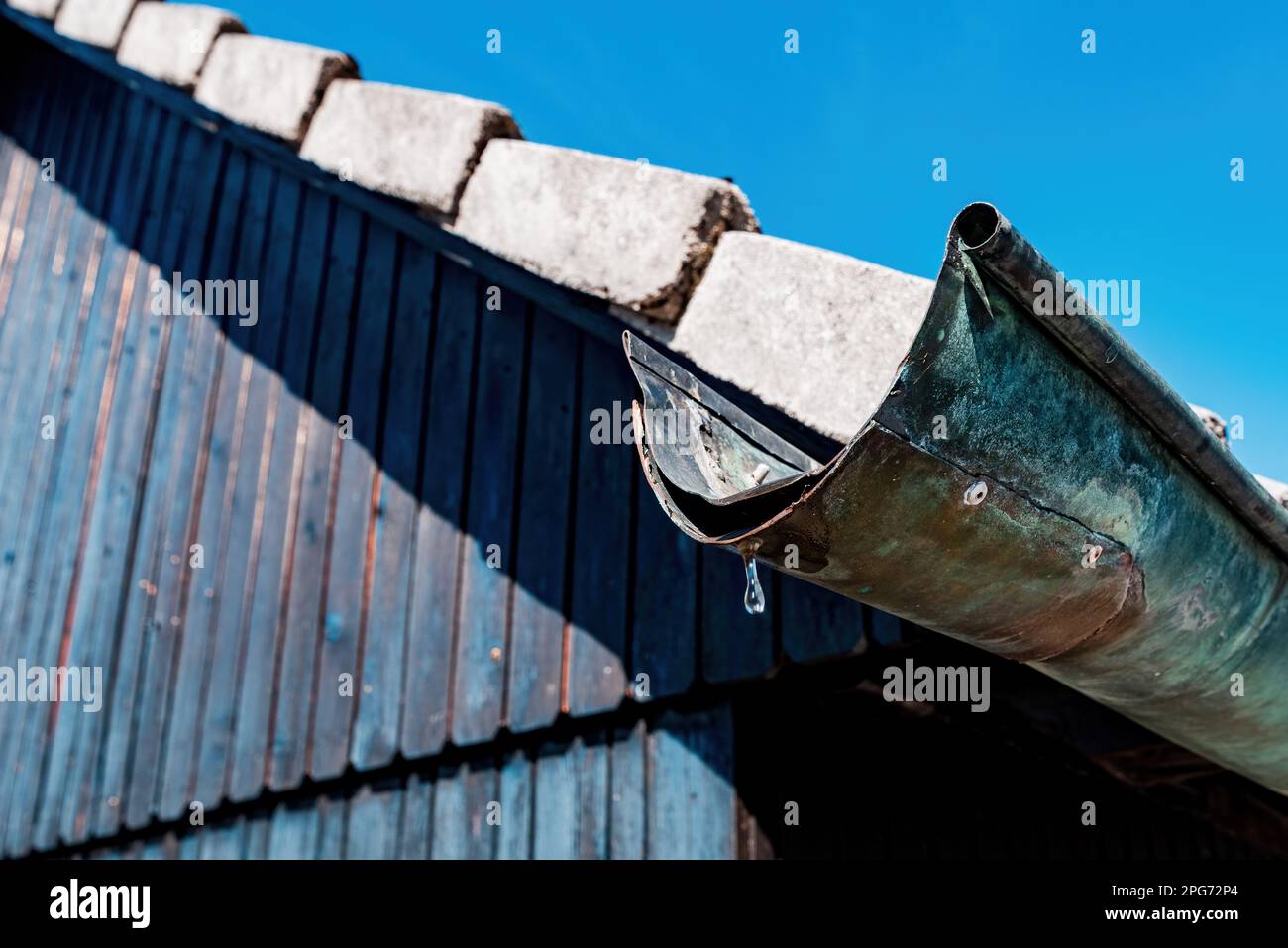 Old worn house rain gutter with water drop, selective focus Stock Photo ...