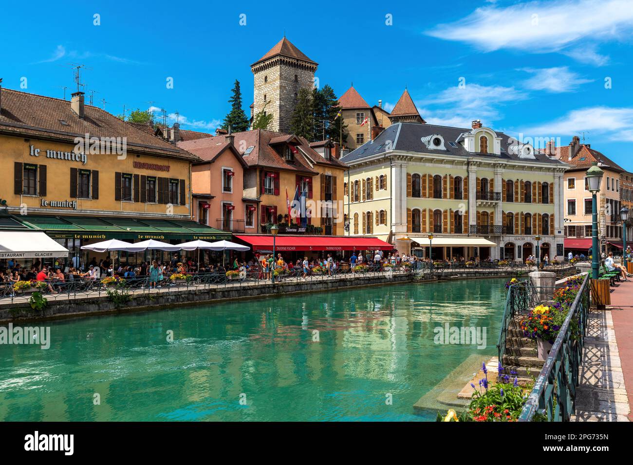 View of canal along promenade with outdoor restaurants and colorful ...