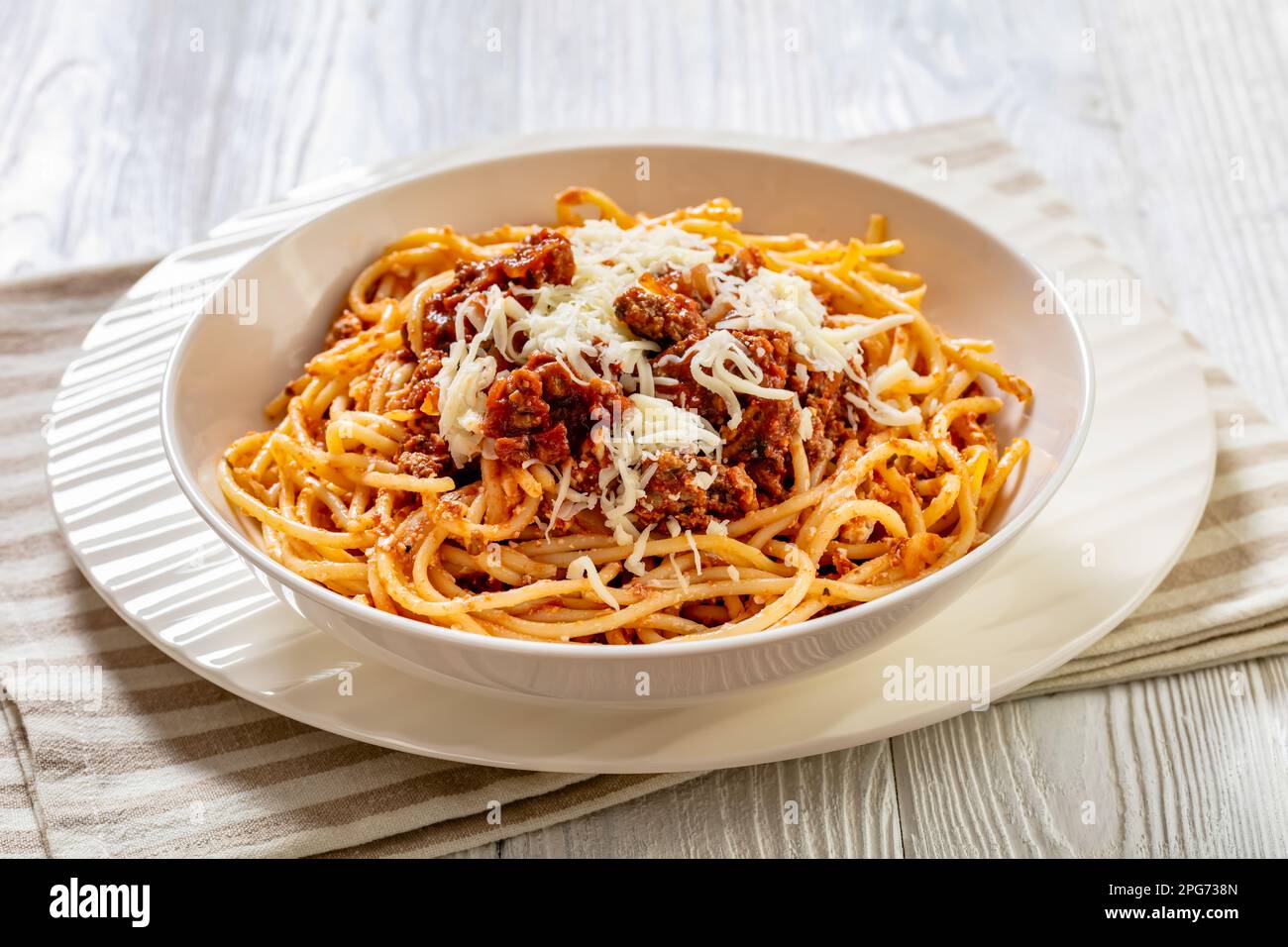 spaghetti al ragu alla Bolognese topped with shredded cheese in white ...