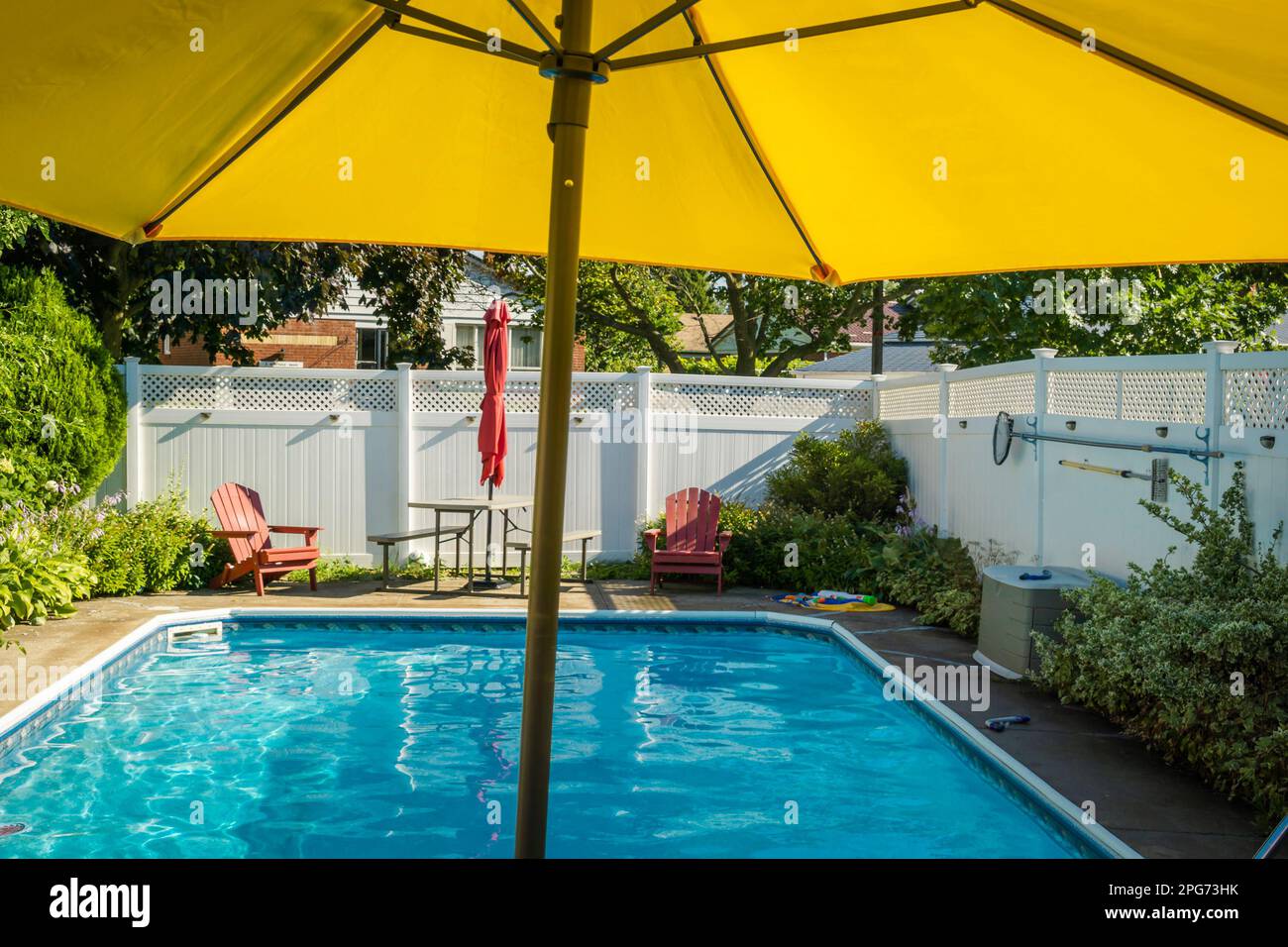Large yellow umbrella facing an indoor water filled pool Stock Photo ...