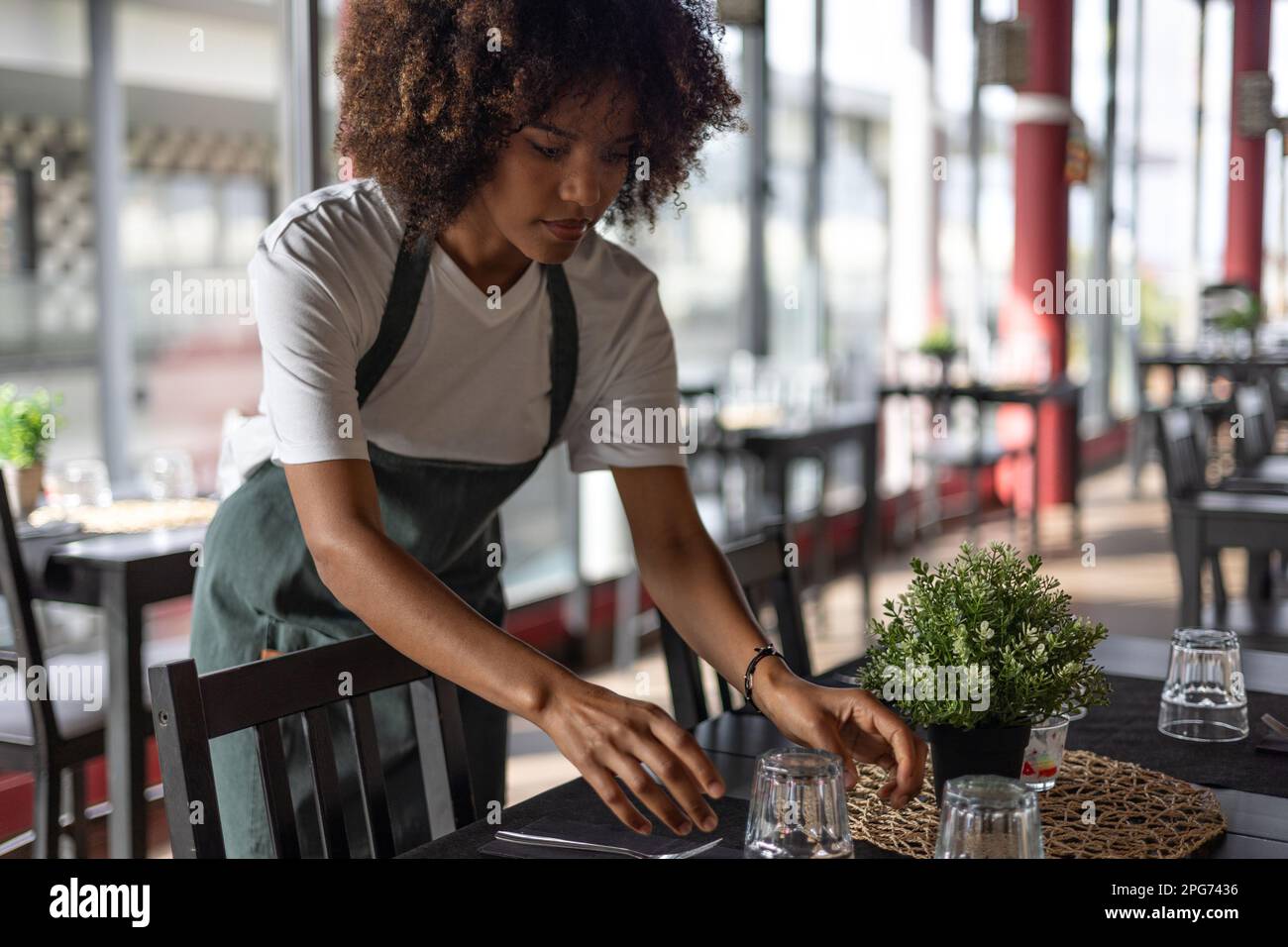 Young African waitress woman at work Stock Photo - Alamy