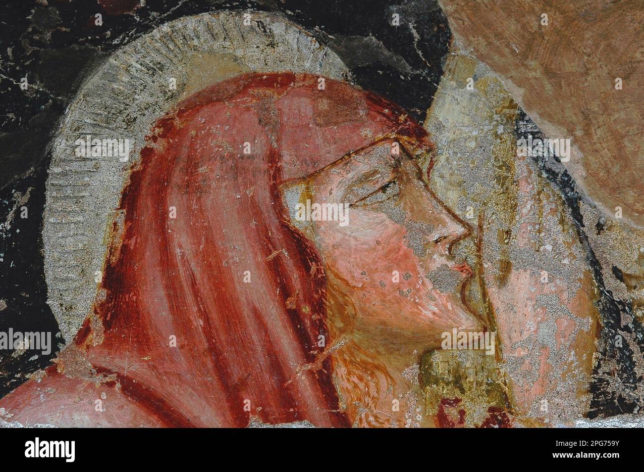 A woman, probably the female disciple Mary Magdalene, kisses the ...