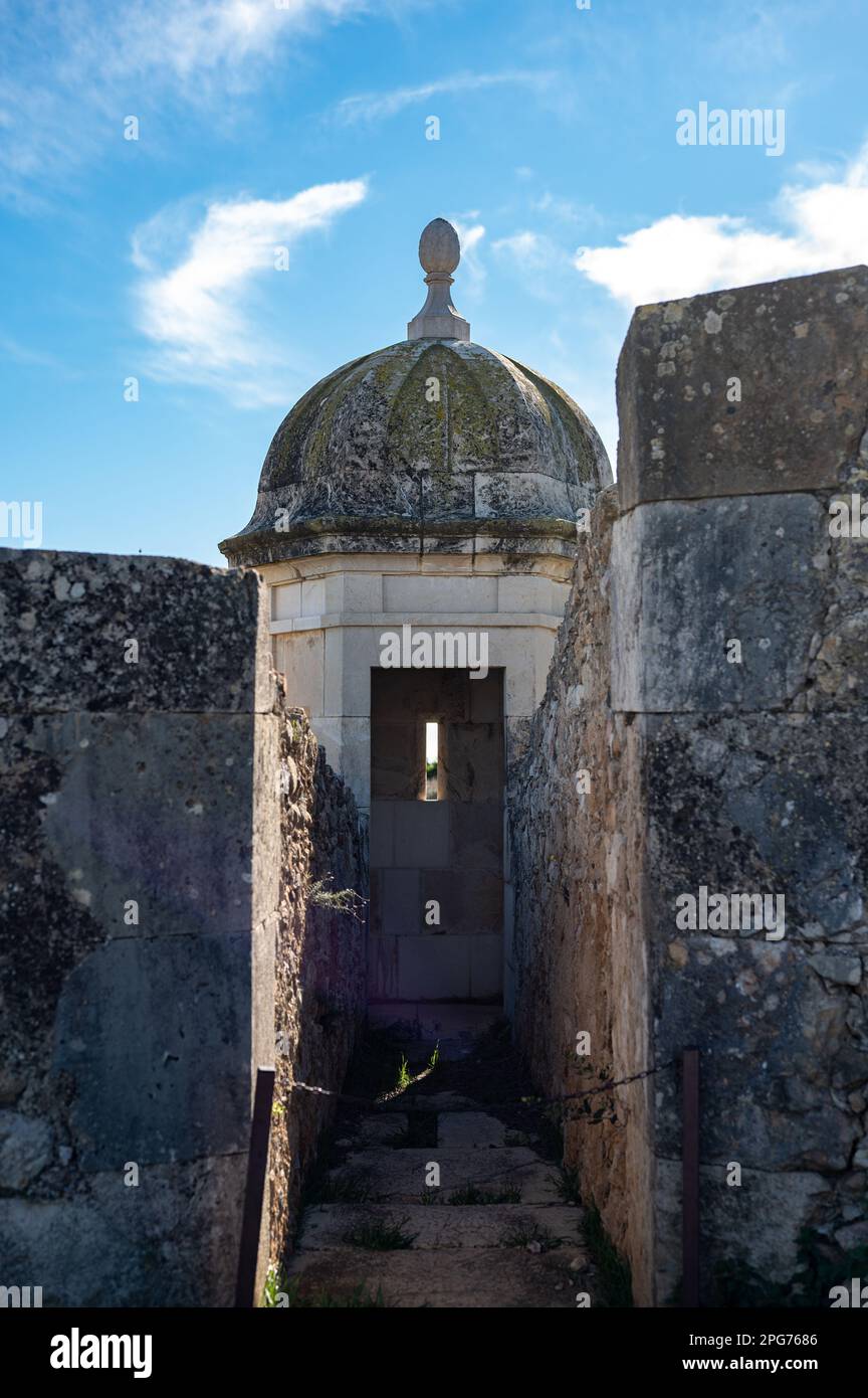 An exterior shot of a quaint stone building, featuring an open window ...