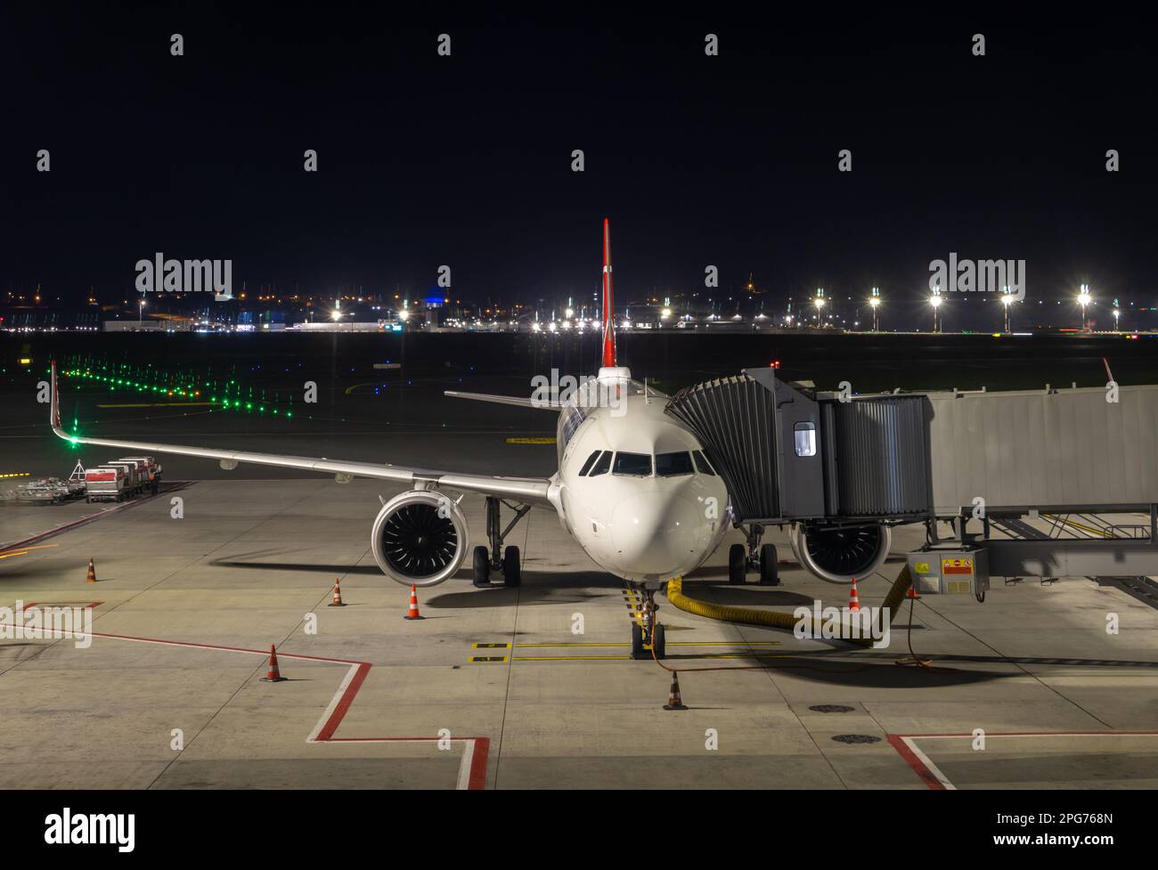 The plane stands at the boarding bridge at night Stock Photo - Alamy