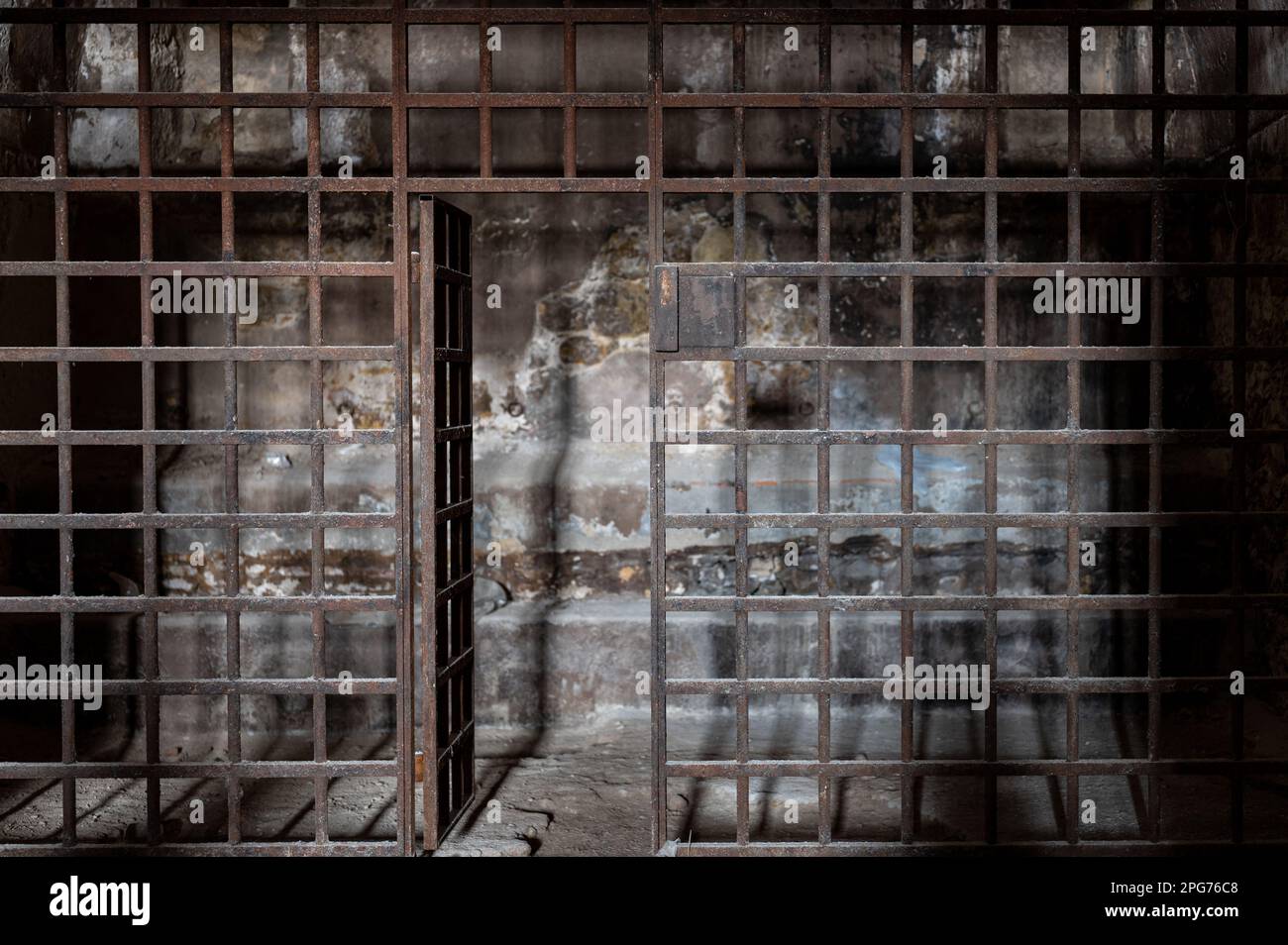 An industrial-style window with metal bars affixed to it, providing an ...