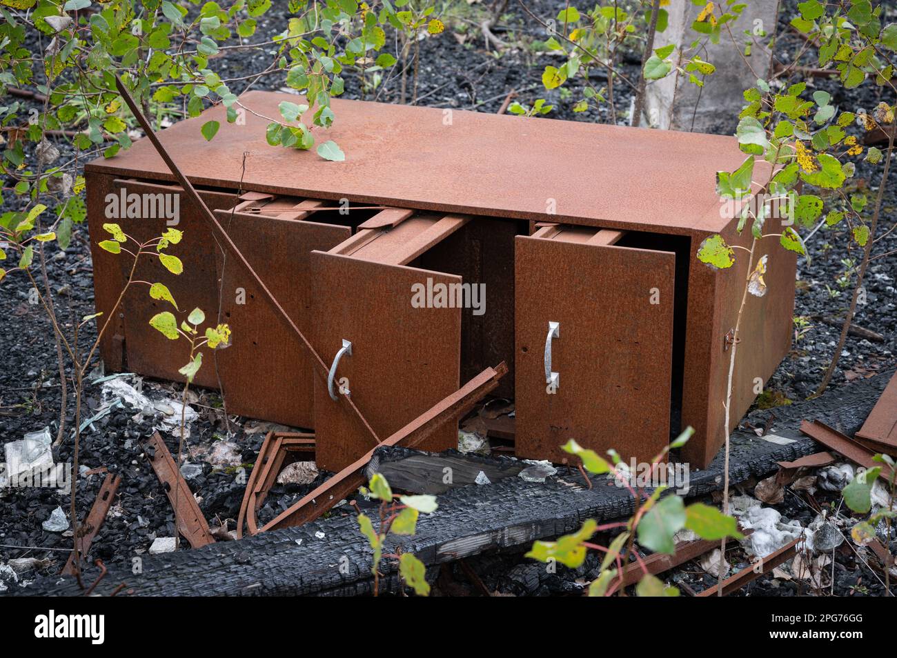 An outdoor workspace comprised of a broken wooden desk and metal frame ...