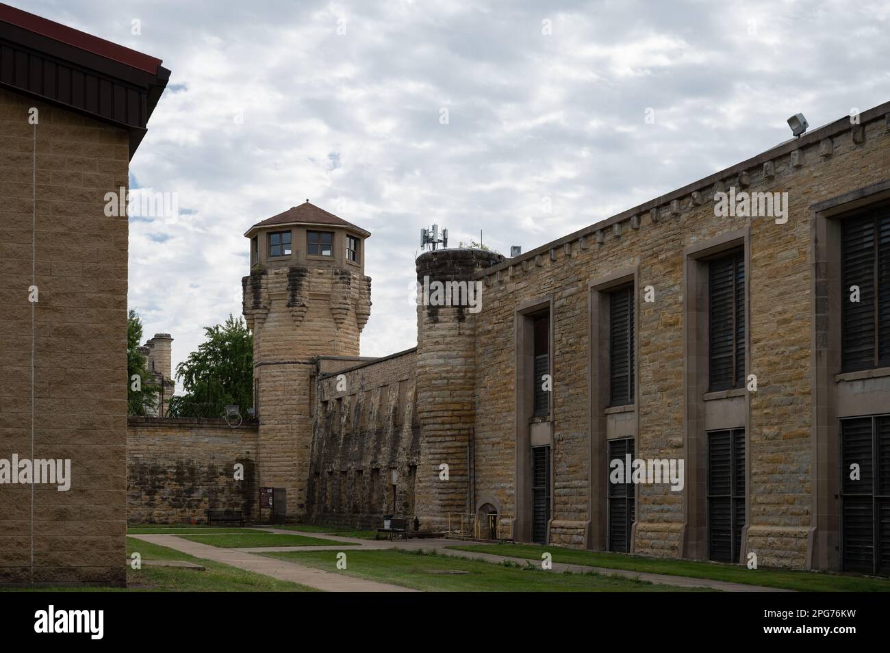 An impressive stone edifice featuring a clock tower in the center, with ...