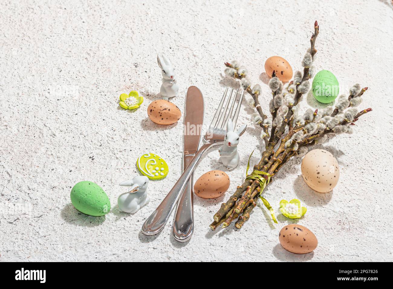 Easter table setting with eggs, rabbits and willow. Traditional festive ...