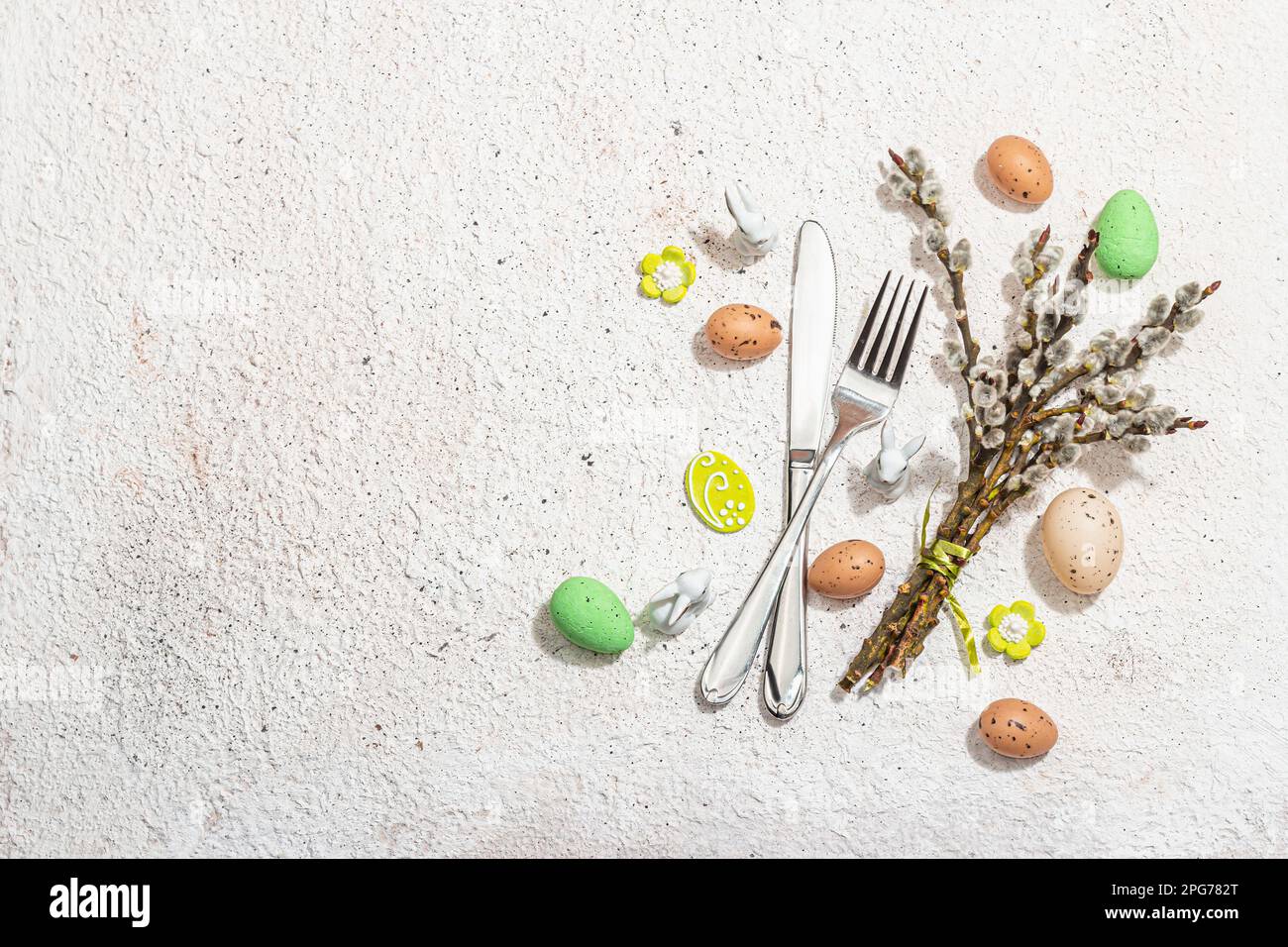 Easter table setting with eggs, rabbits and willow. Traditional festive ...