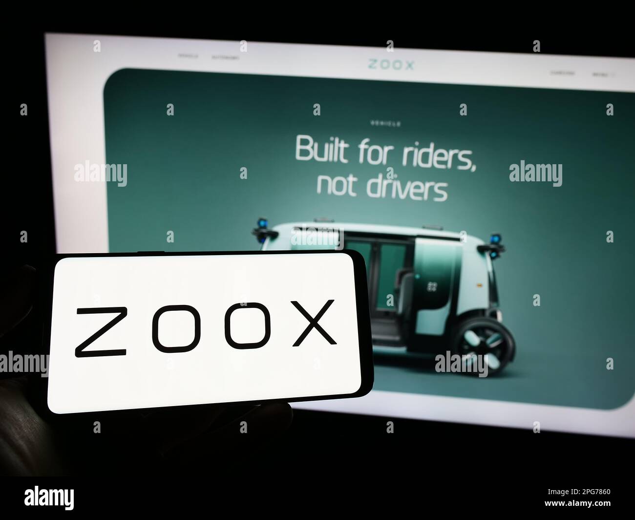 Person holding mobile phone with logo of American autonomous vehicle ...