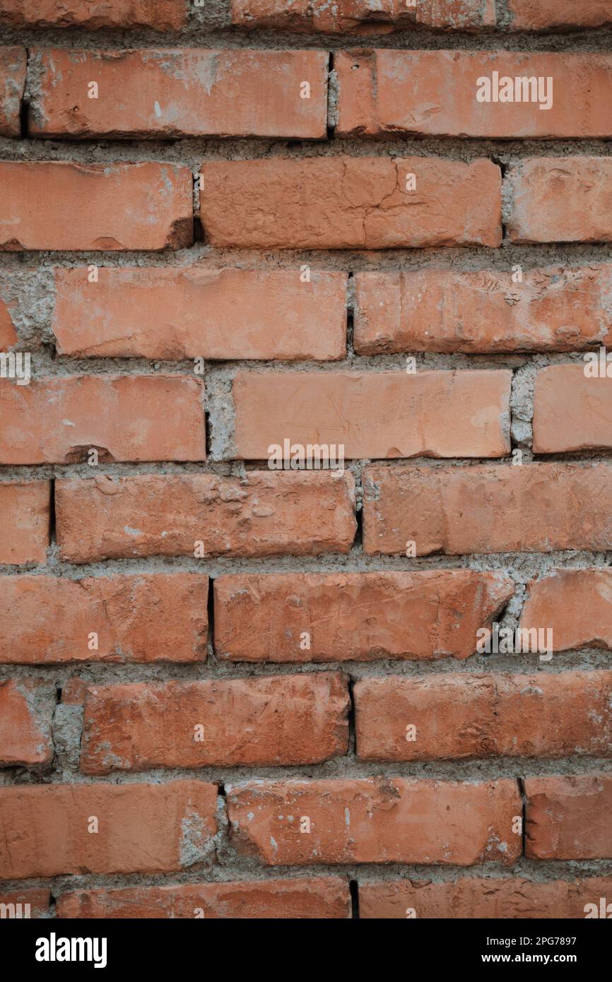 A textured brick wall featuring unique patterns in a variety of shades ...