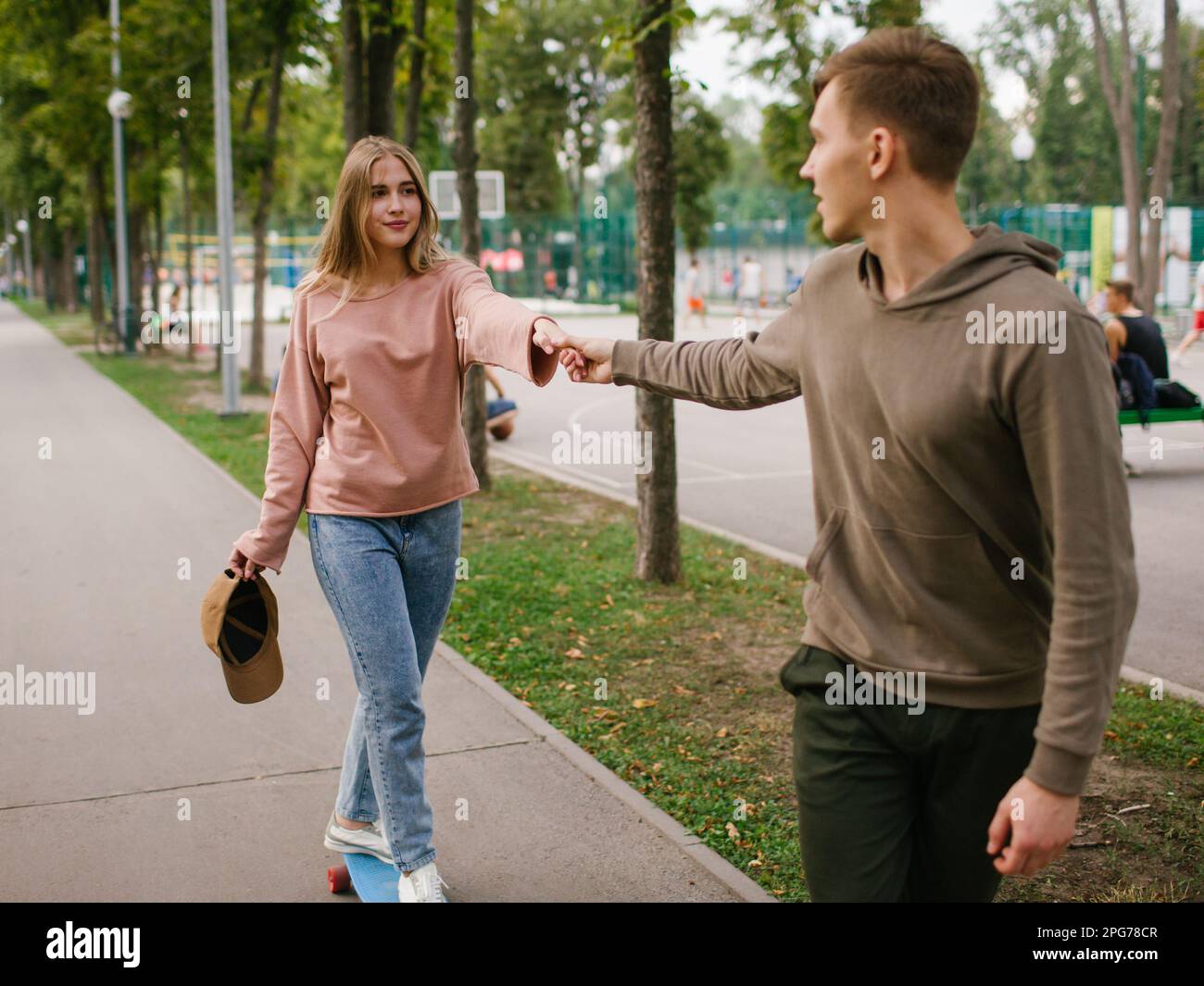teaching skateboarding active lifestyle trust Stock Photo - Alamy