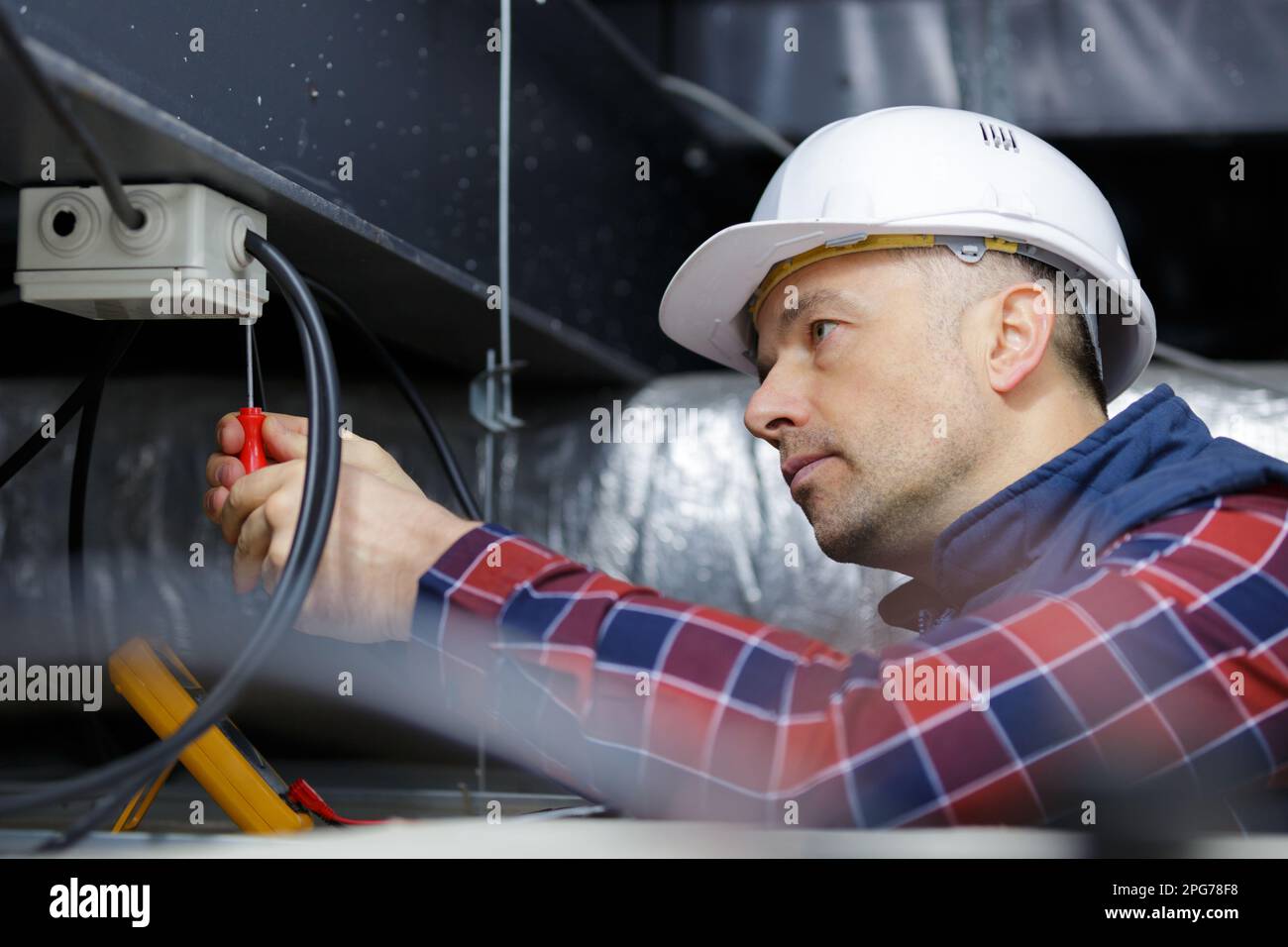 electrical worker wiring in ceiling Stock Photo - Alamy