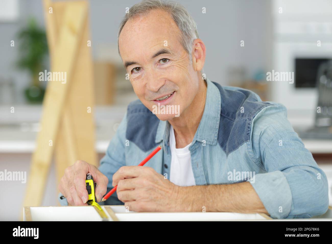 senior man with tape measure Stock Photo - Alamy