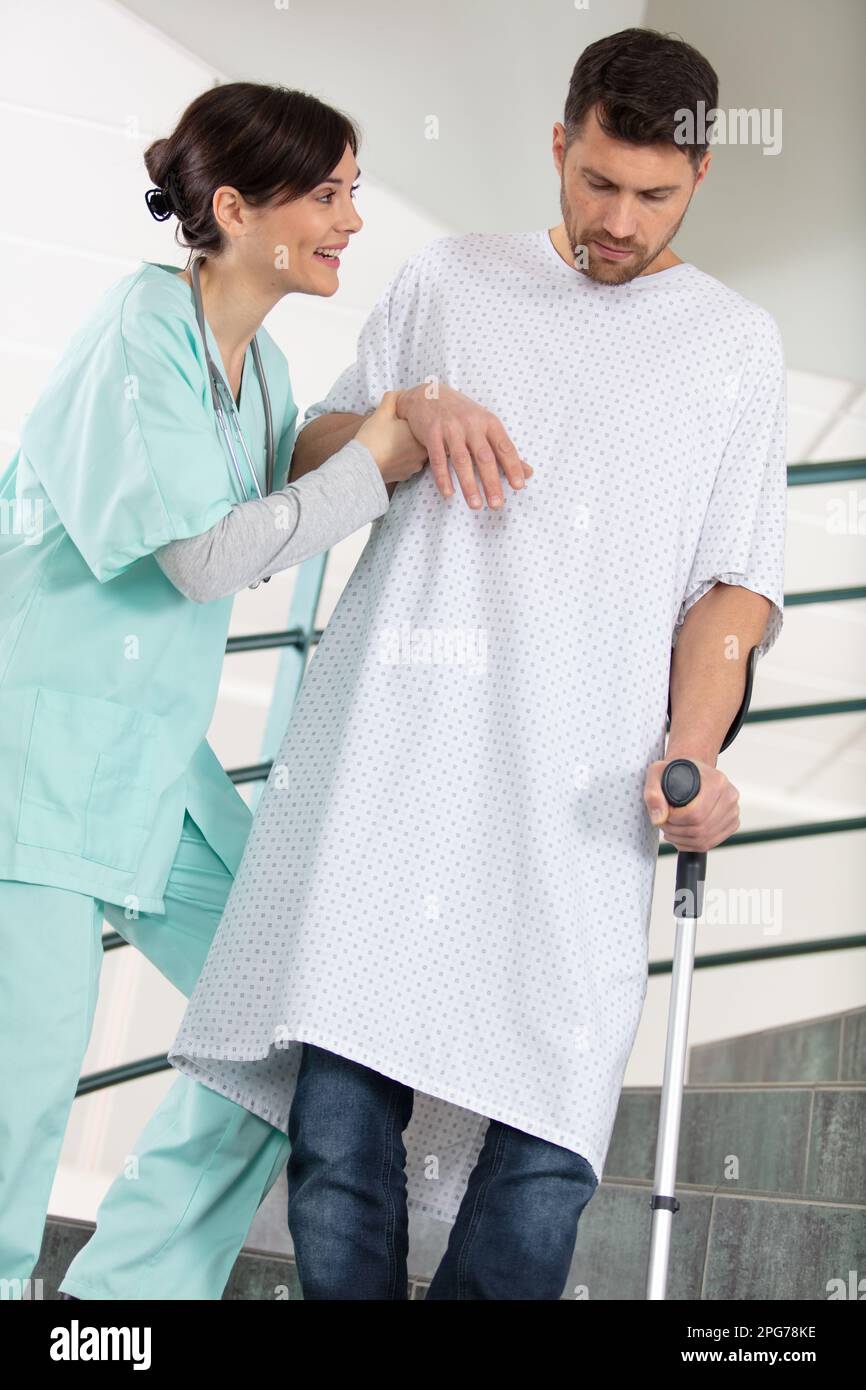 female nurse assisting a patient in hospital stairs Stock Photo - Alamy