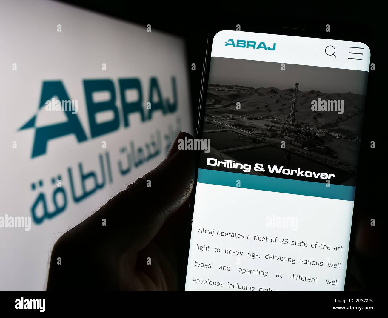 Person holding smartphone with webpage of Omani oil company Abraj ...