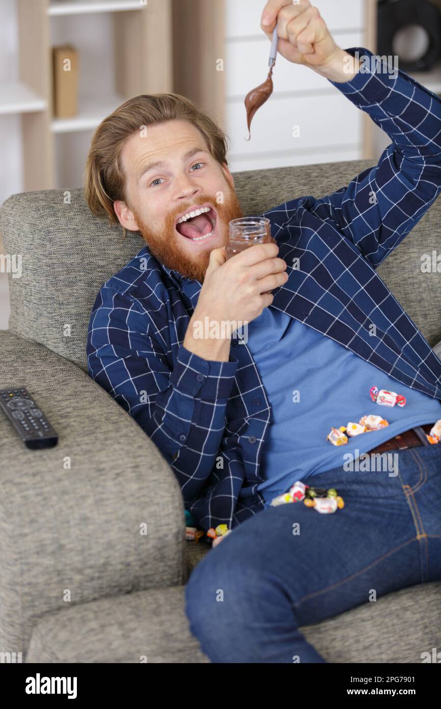man eating chocolate spread from the jar Stock Photo - Alamy