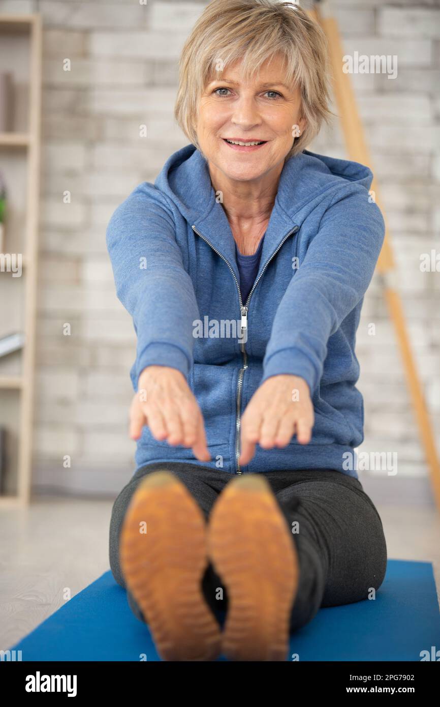 mature professional woman exercising and stretching her body Stock ...