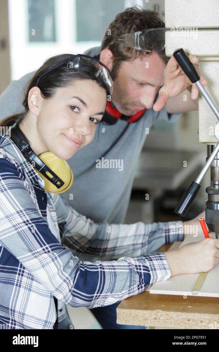 young woman as apprentice in wood construction Stock Photo - Alamy