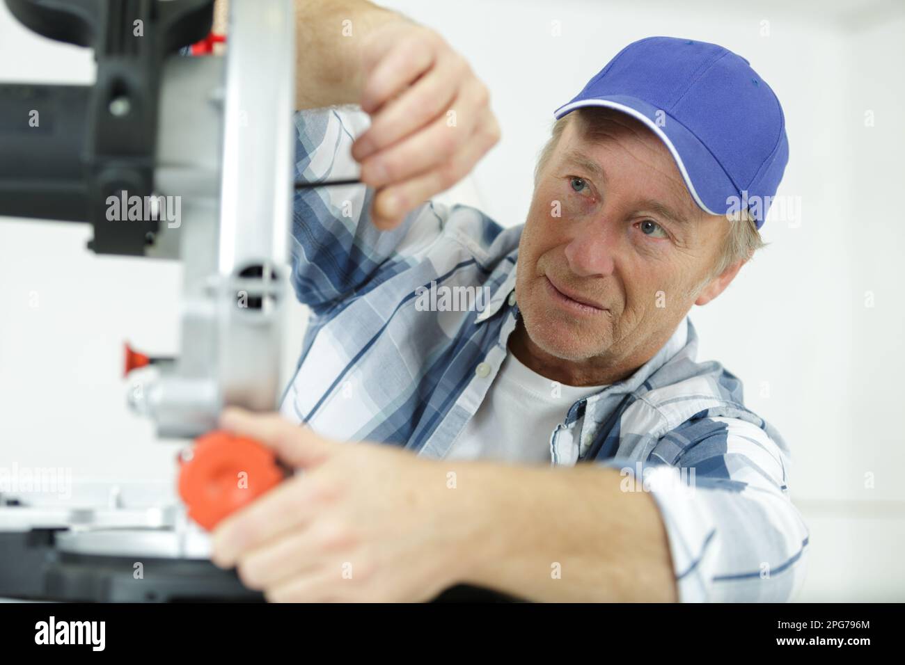 senior man using table saw for cutting wood at workbench Stock Photo ...
