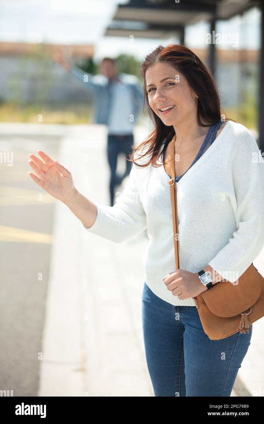 woman she raised her hand waving calling the bus Stock Photo - Alamy
