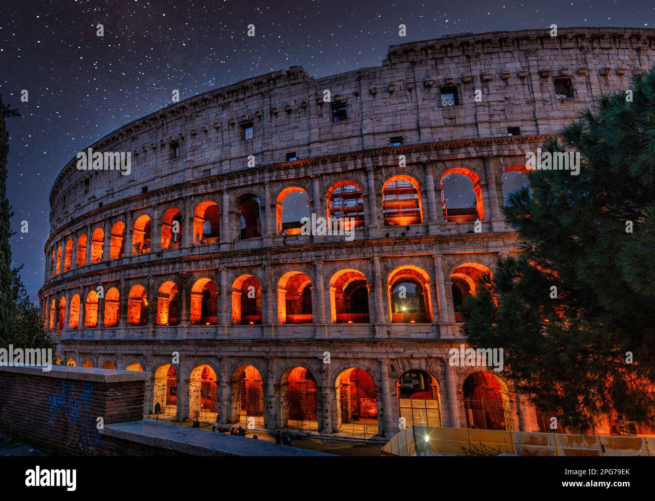 The Colosseum illuminated with lights in the evening in Rome, Italy ...