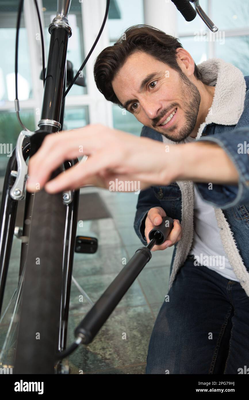 man inflating his bicycle tire Stock Photo - Alamy