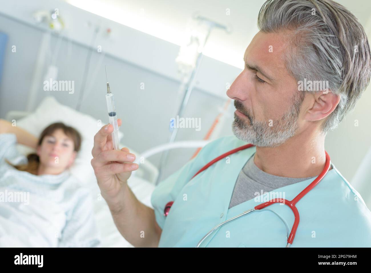 doctor preparing syringe for patient in hospital bed Stock Photo - Alamy