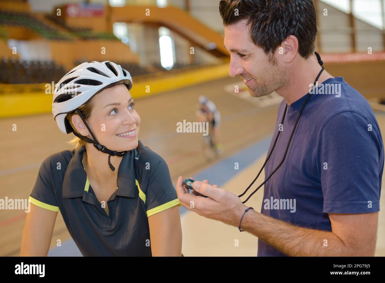 female cyclist in a velodrome with coach Stock Photo - Alamy