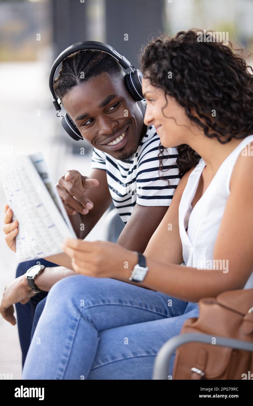 tourists travelers waiting happily in a train station Stock Photo - Alamy