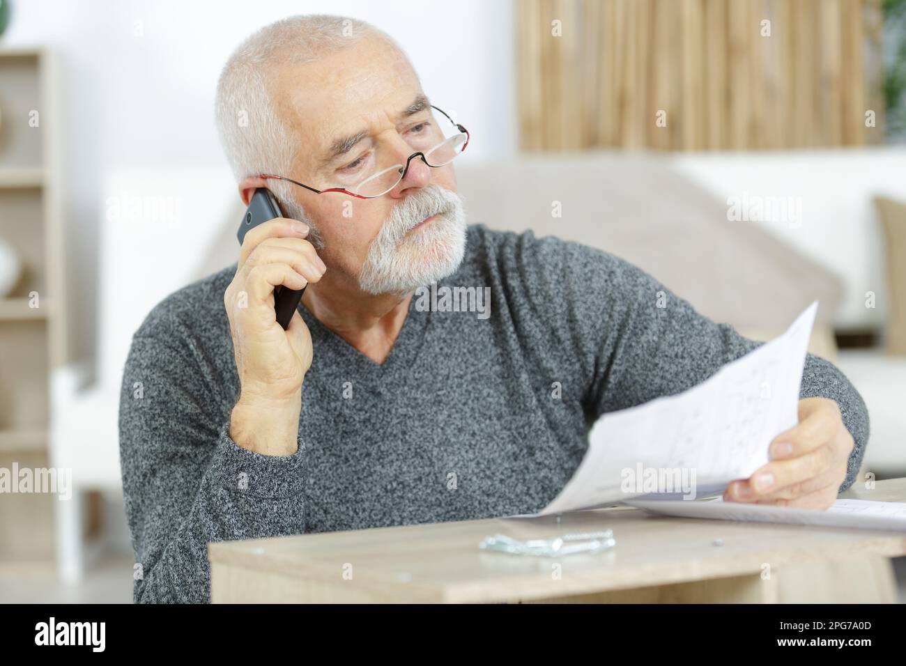 shocked senior man looking at bills Stock Photo - Alamy