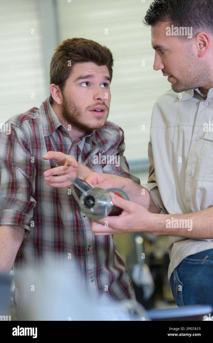 a young mechanical engineer with apprentice Stock Photo - Alamy