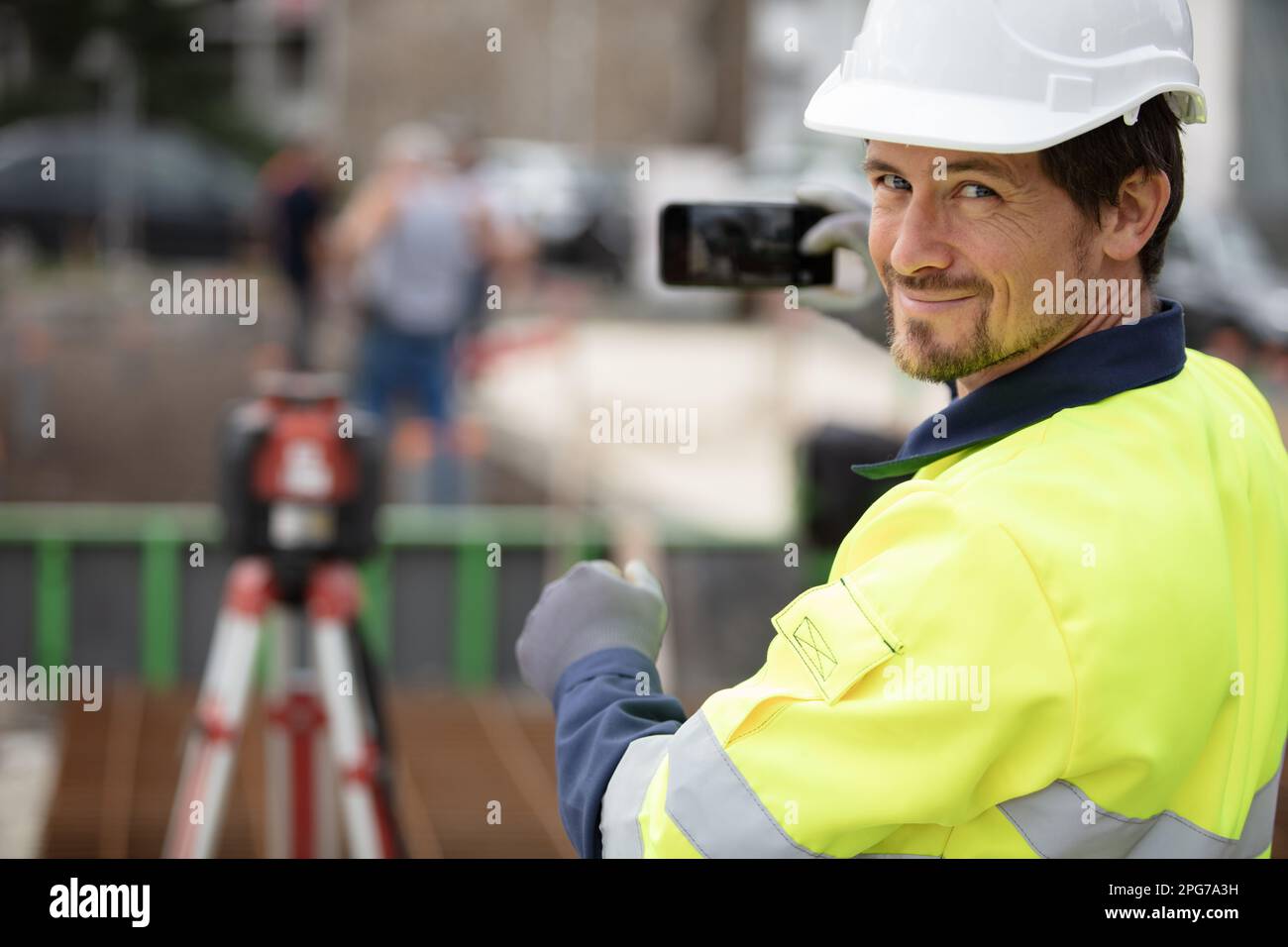 land surveyor at work on a building site Stock Photo - Alamy