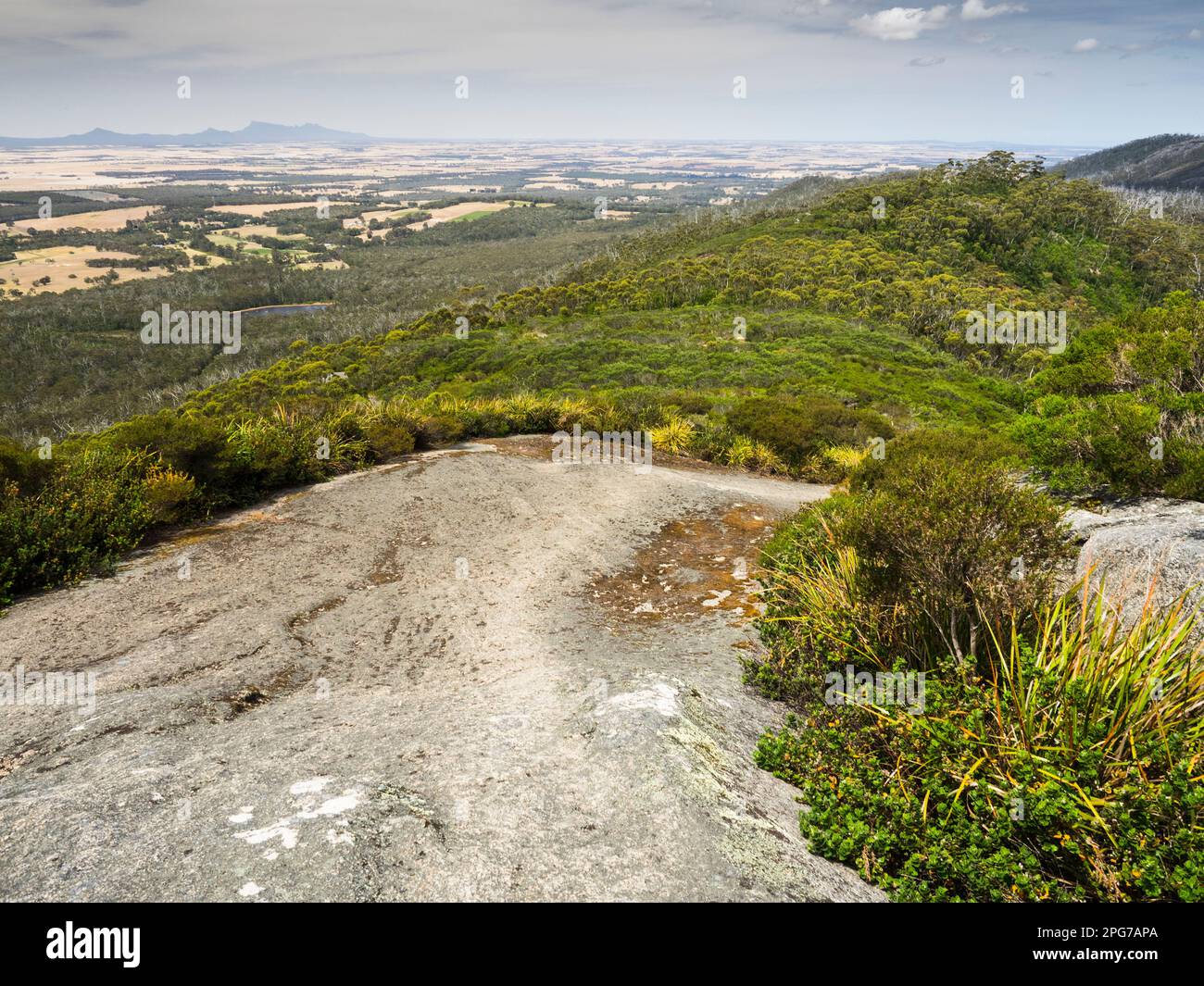 The Stirling Ranges in the distance beyond farmland from a granite slab ...